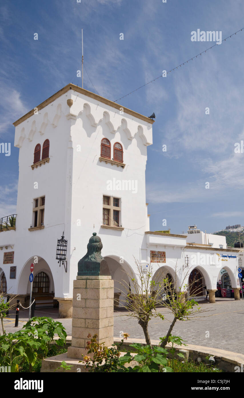The landmark white towered building along the waterfront of Skala Town ...