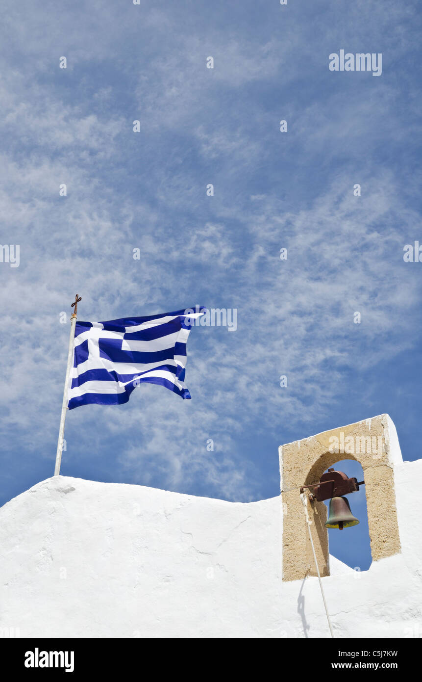 The Greek flag flying above a small church bell in Patmos, Greece Stock ...