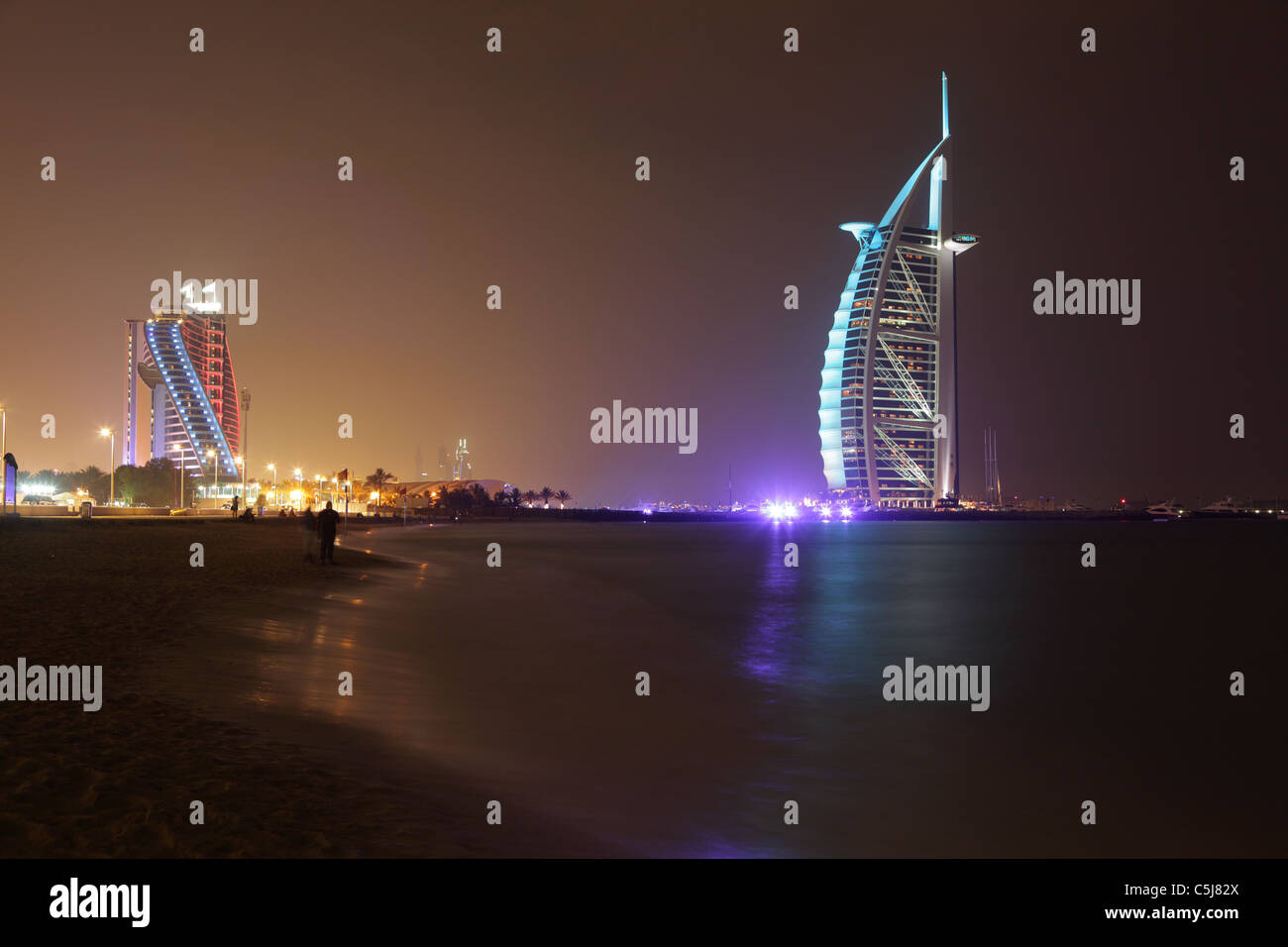 Jumeirah beach with Burj Al Arab and Jumeirah Beach Hotel illuminated ...