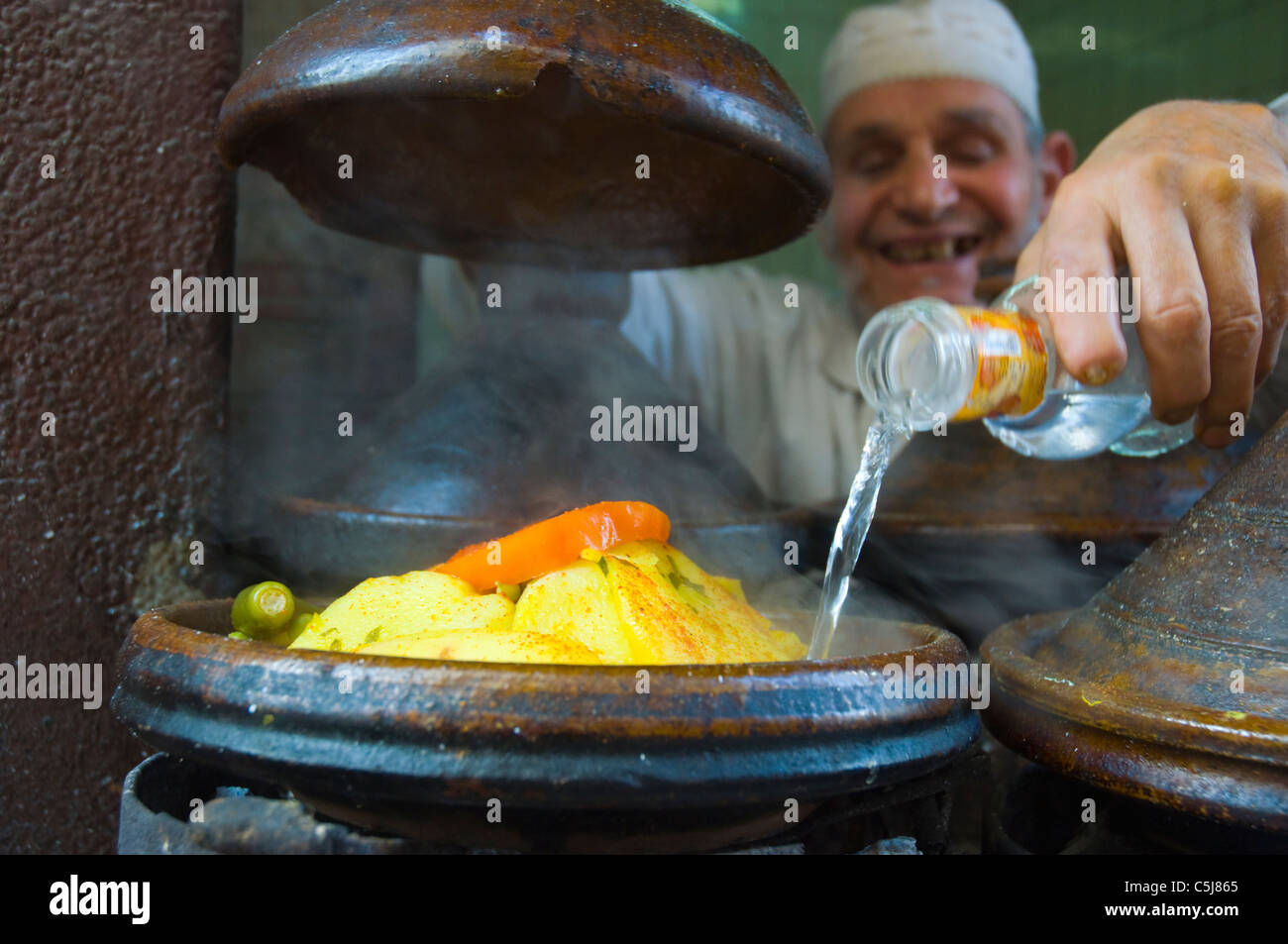 Man adding water into tagine pot Medina old quarter Casablanca central ...