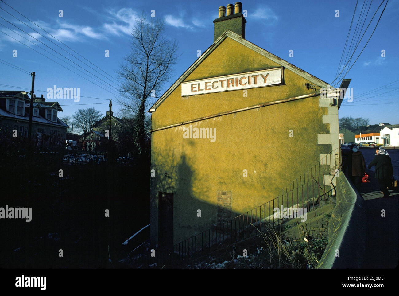 Yellow gable of old-style village house, carrying a wooden sign with ...