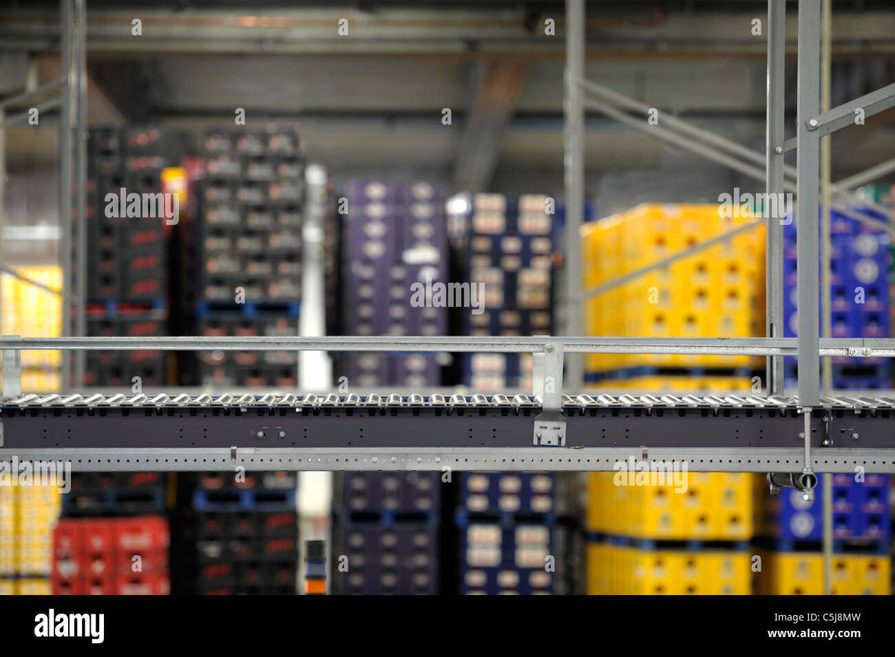 beerbottele crates passing on a conveyor in bottling factory. stacks of ...