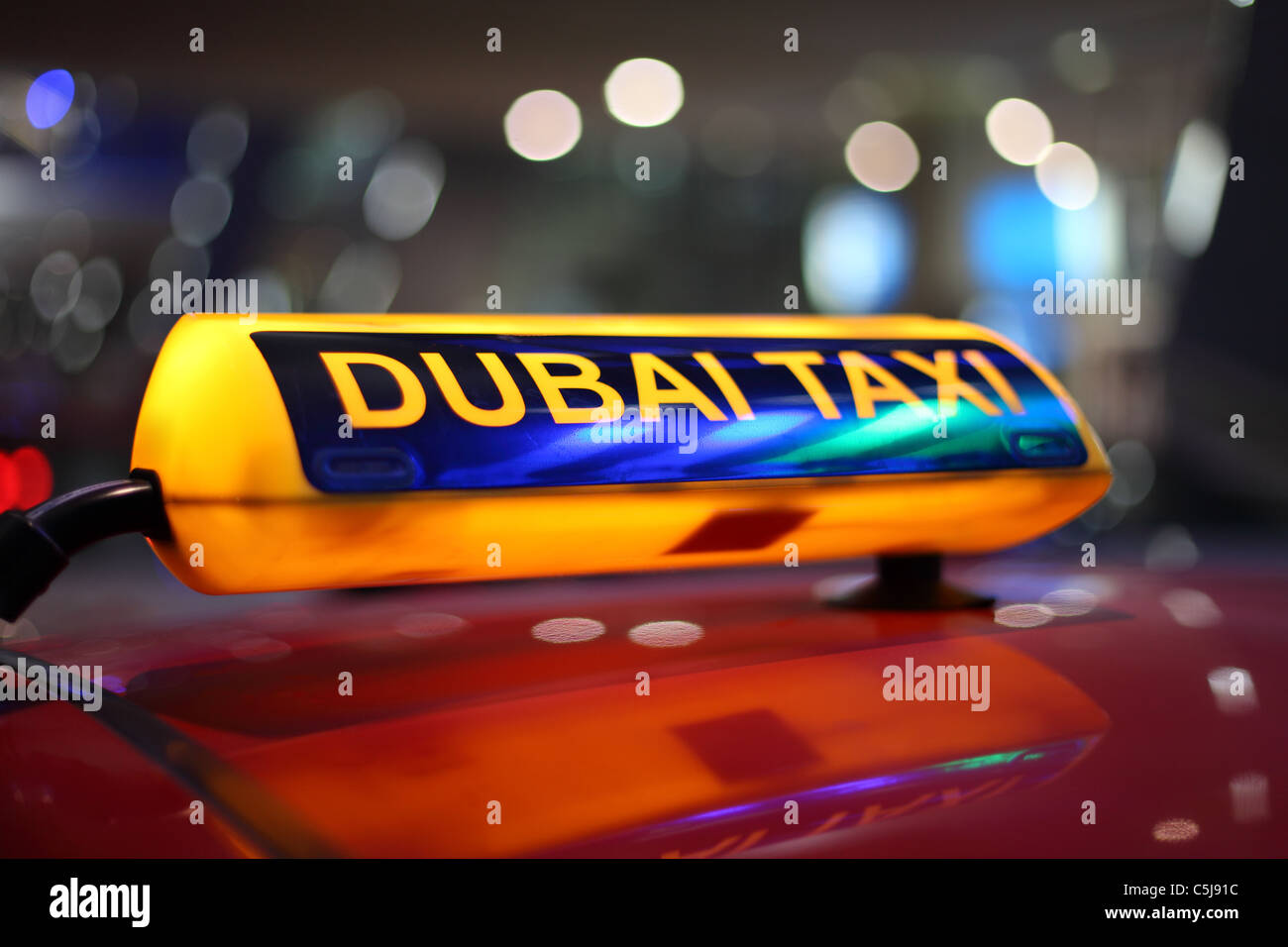 Dubai taxi sign at night Stock Photo - Alamy