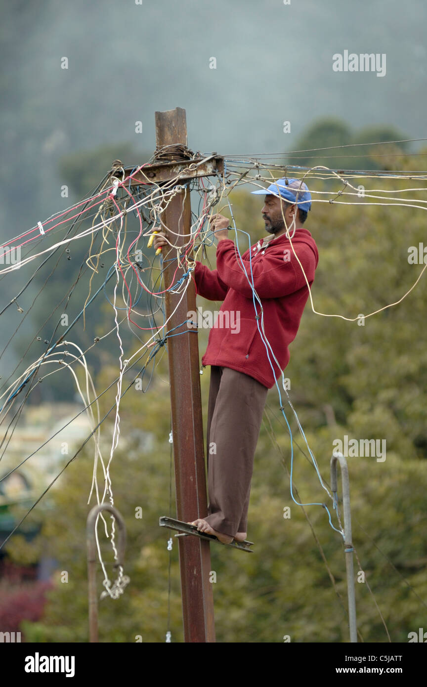 India, Tamil Nadu, Coonoor 2005. Indian electrician working on wiring ...