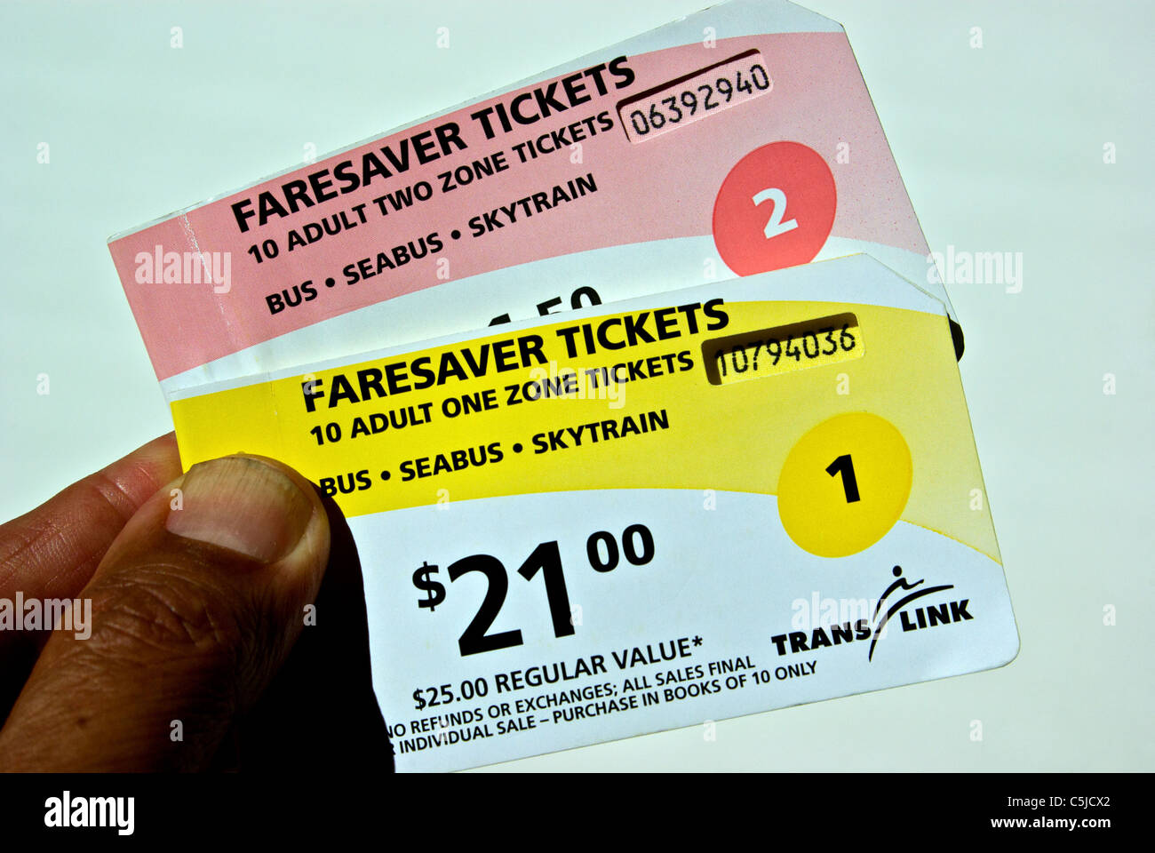 Hand holding books of Translink one two zone faresaver bus and light ...