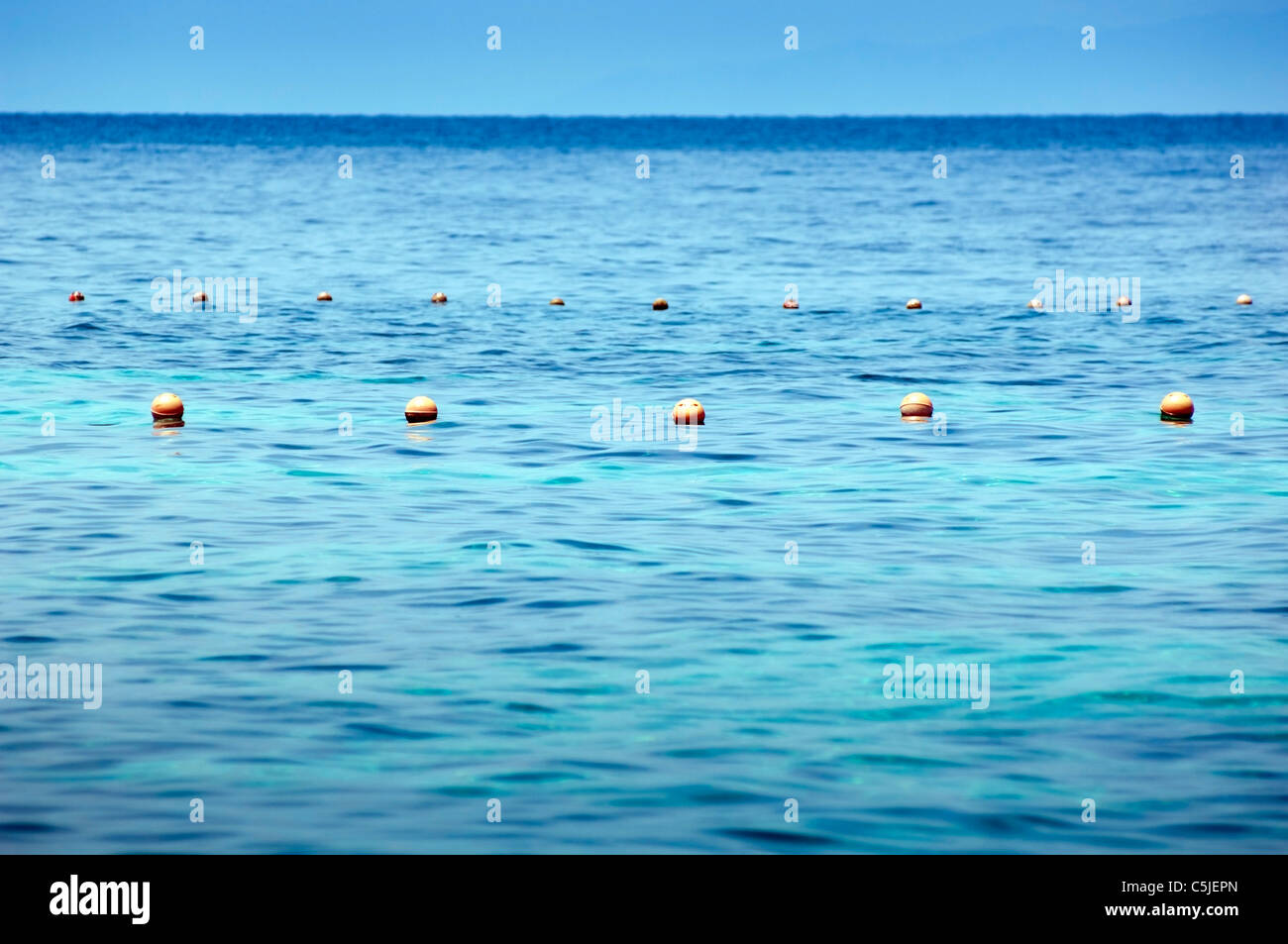 Simple composition of ocean buoys in rich blue water Stock Photo - Alamy