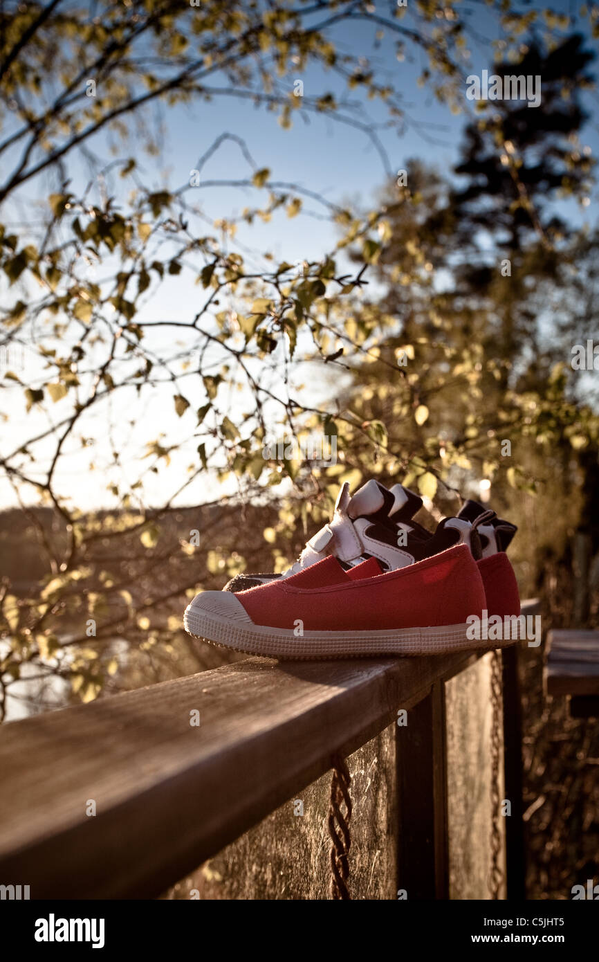 Shoes on a railing Stock Photo - Alamy