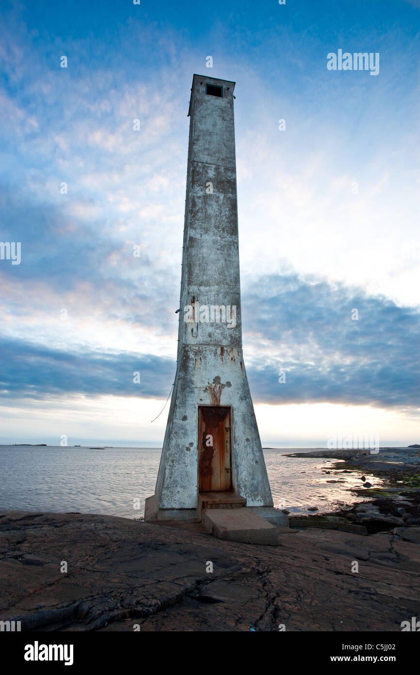 Exterior of abandoned and derelict lighthouse on ocean coastline with ...