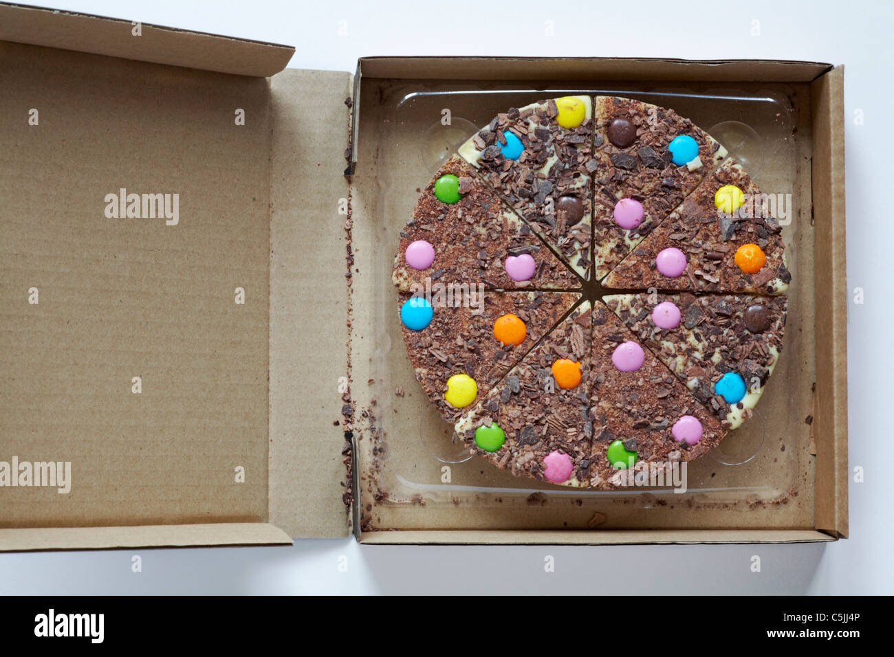 white chocolate pizza with chocolate strands and smarties in box opened ...
