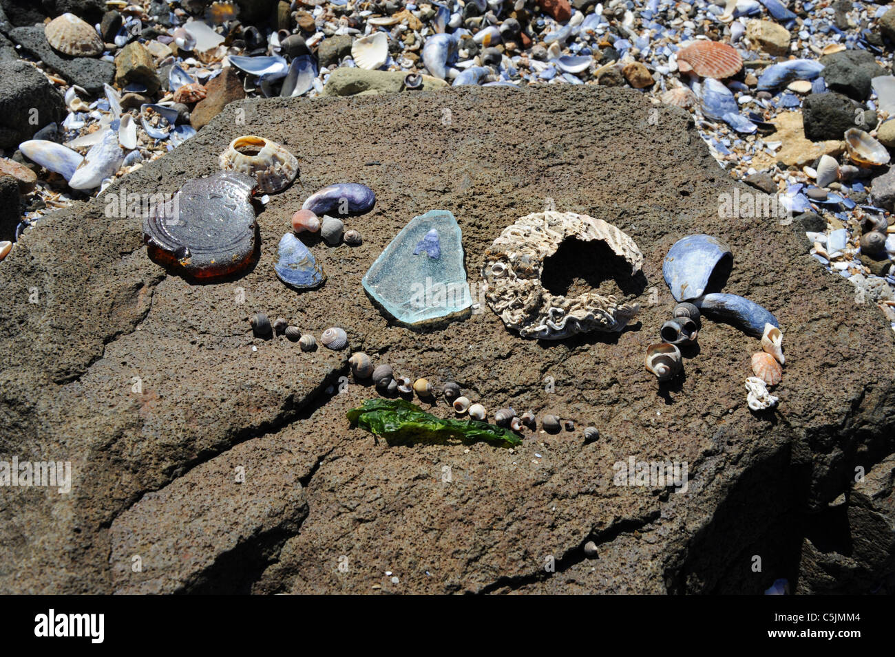 A sign for the beach made out of shells and seaworn glass found on the ...