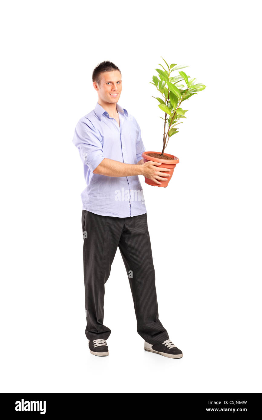 Full length portrait of a happy young man holding a pot with decoration ...