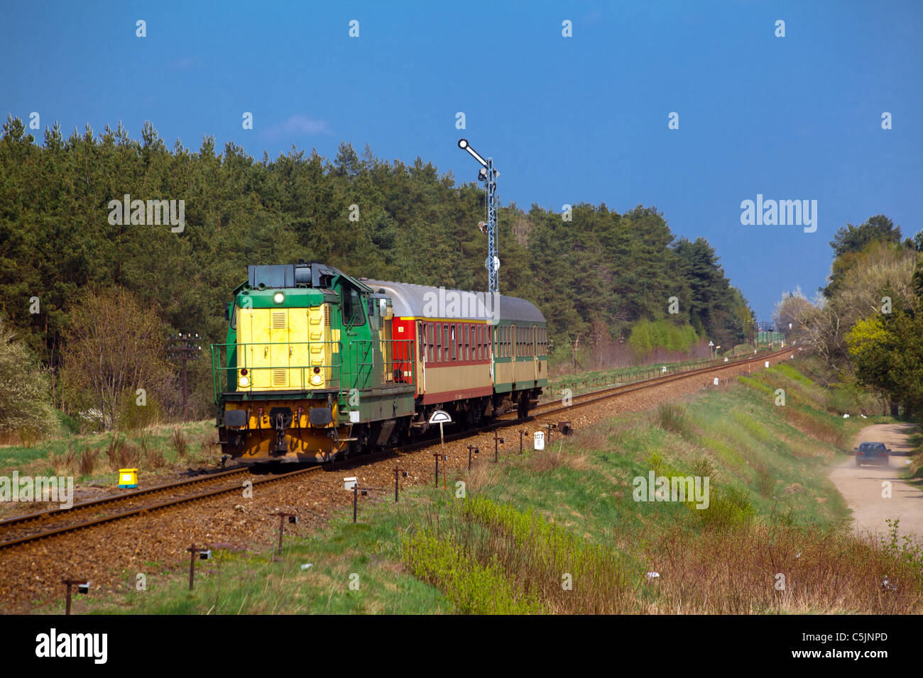 Passenger train passing through countryside Stock Photo - Alamy