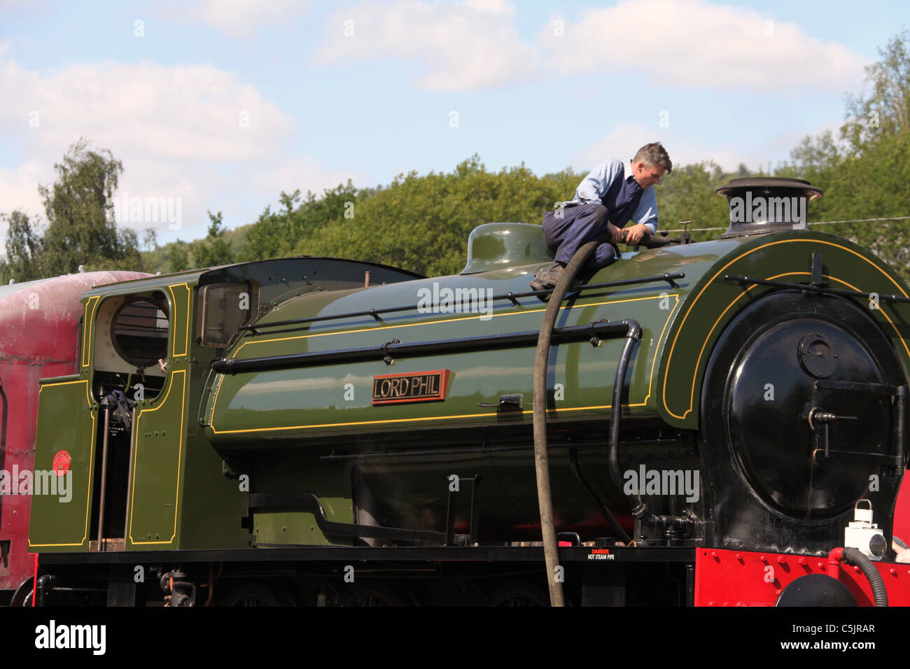 Steam Engine being topped up with water at Peak Rail Stock Photo - Alamy