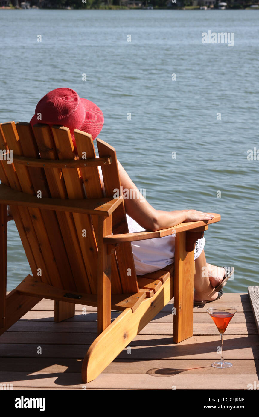 A lady resting next to a lake Stock Photo - Alamy
