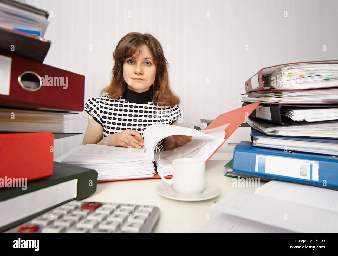 Female accountant very busy working in the office Stock Photo - Alamy
