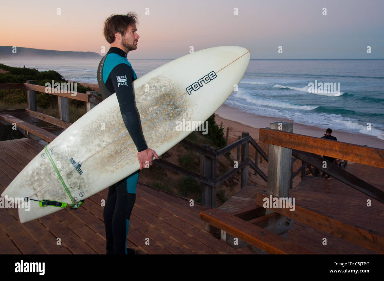 A surfer gets an early morning wave Stock Photo - Alamy