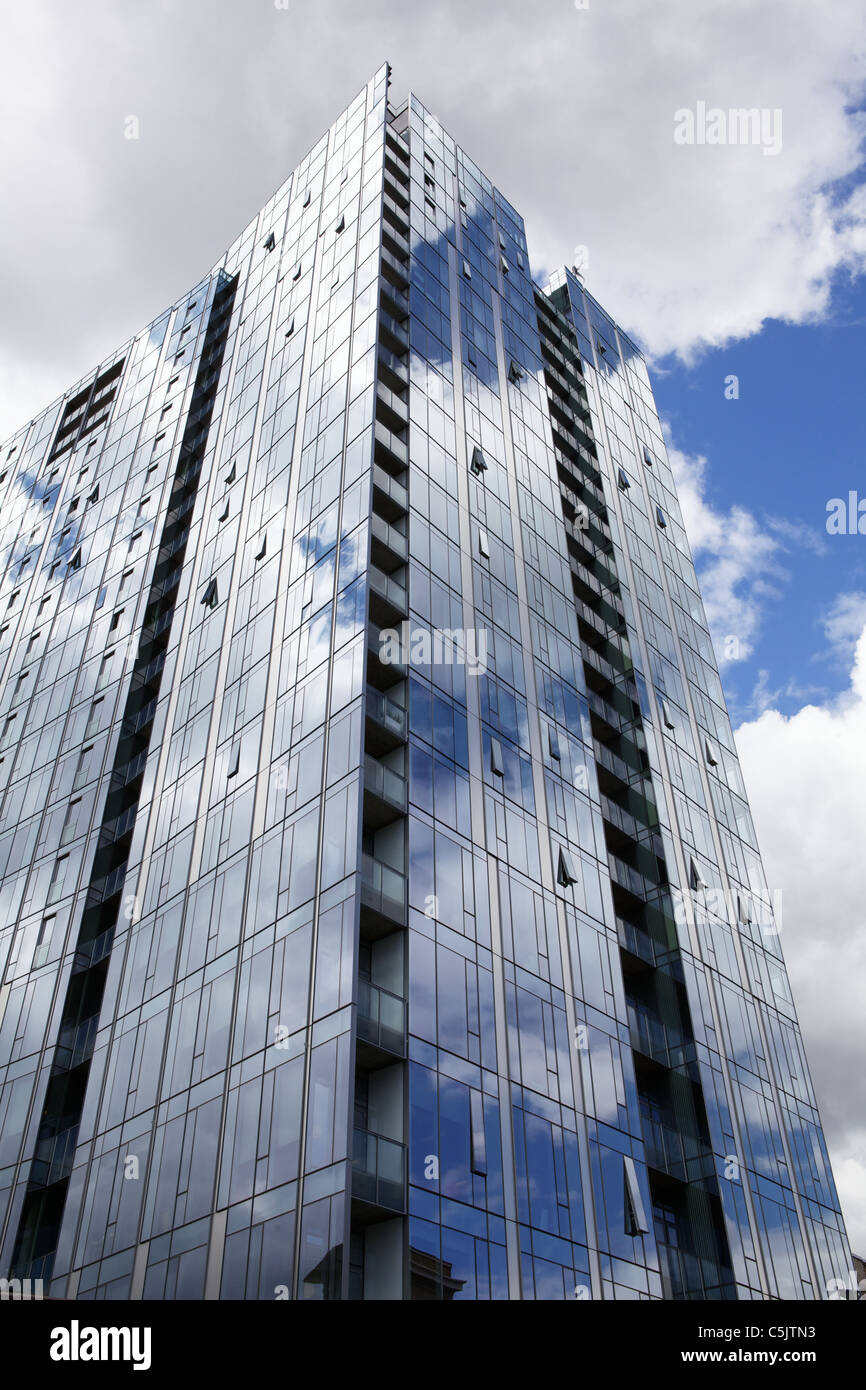 Tall glass covered reflecting skyscraper with blue sky and clouds Stock ...