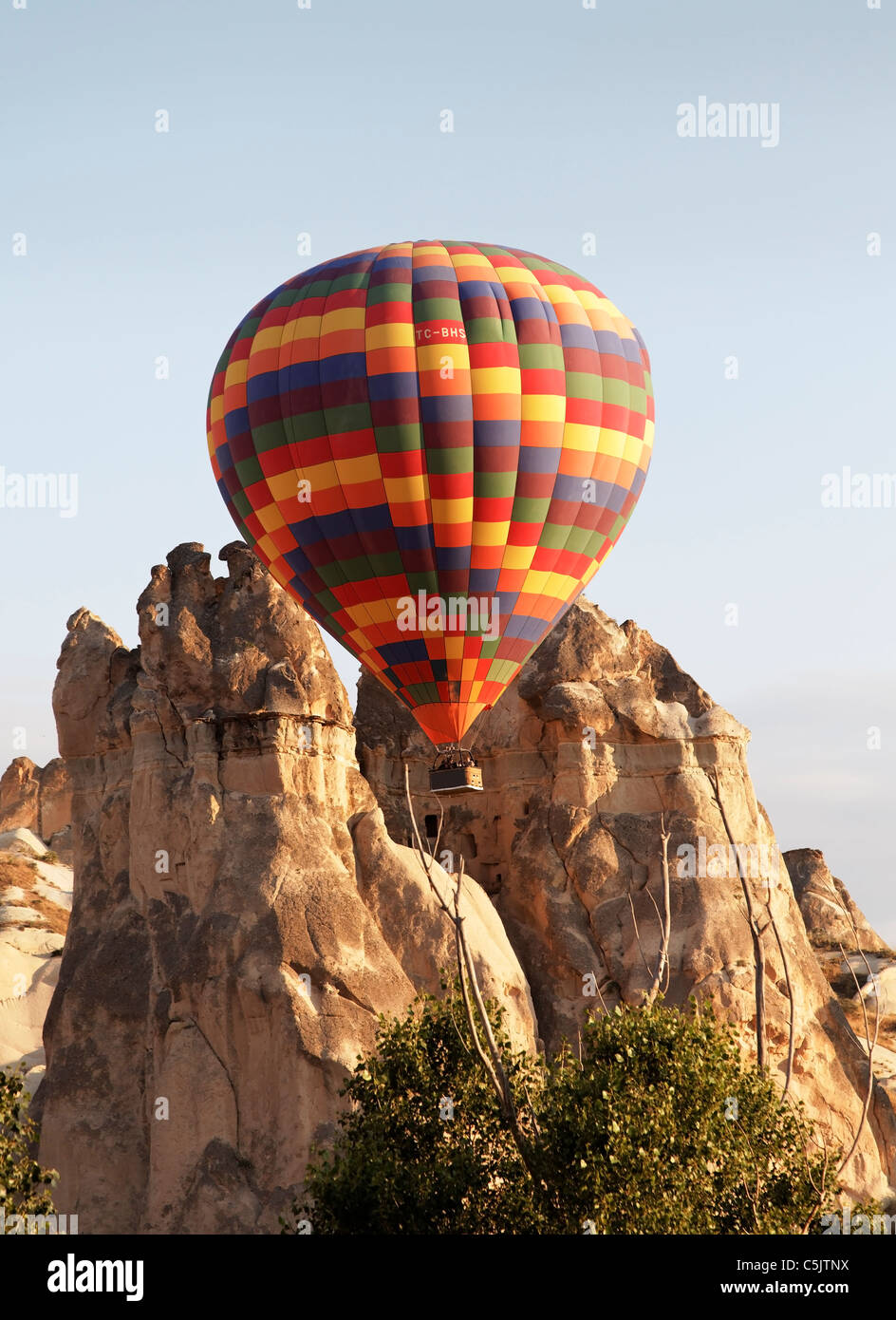 Multi colored hot air balloon against limestone sand stone rock ...