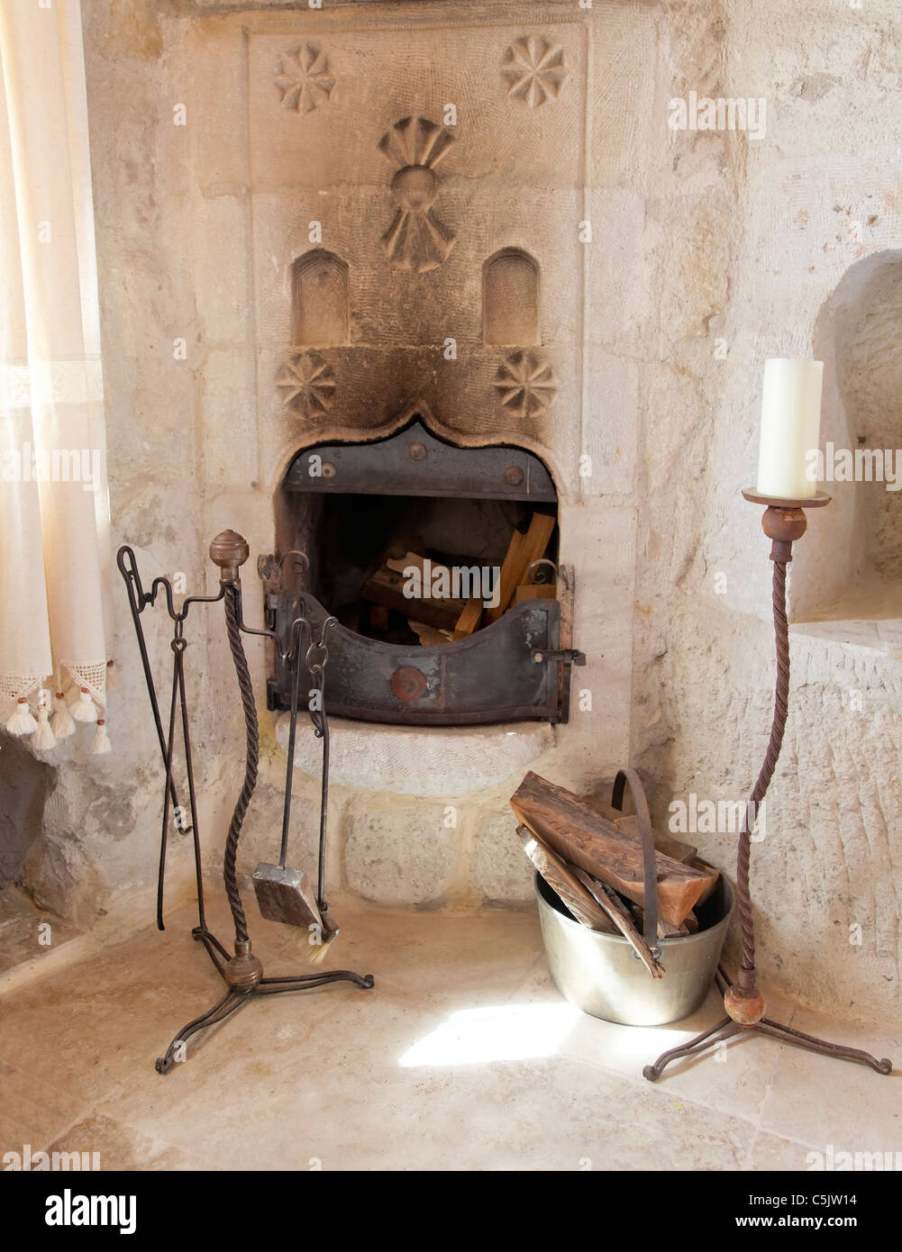 Corner style open log fireplaces with tools and logs cut iinto a ...