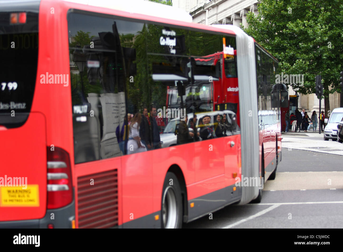 The side and rear view of a bendy bus Stock Photo - Alamy