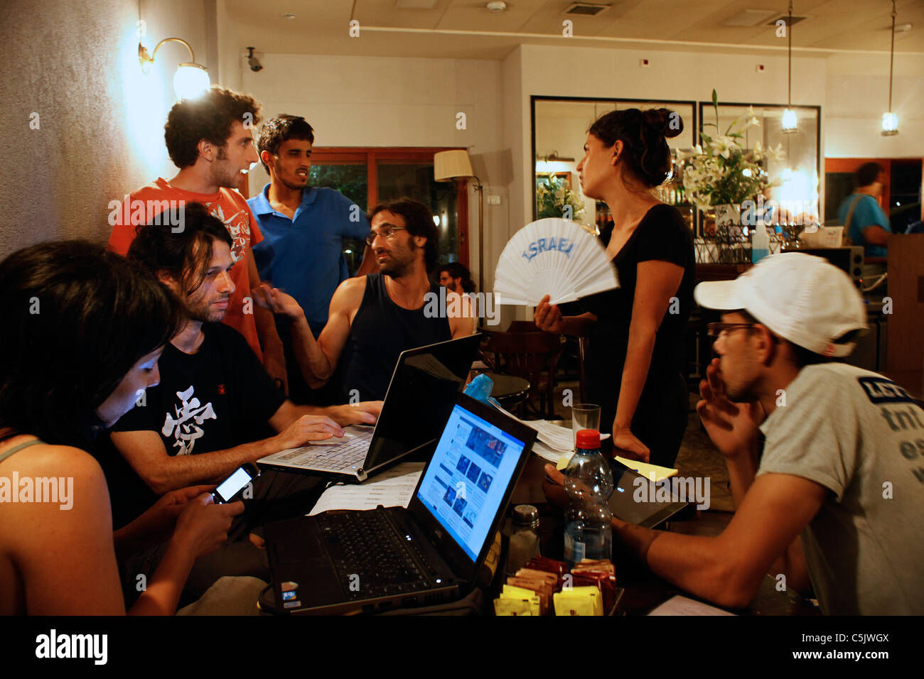 Activists work on their laptops as they gather for strategic discussion ...