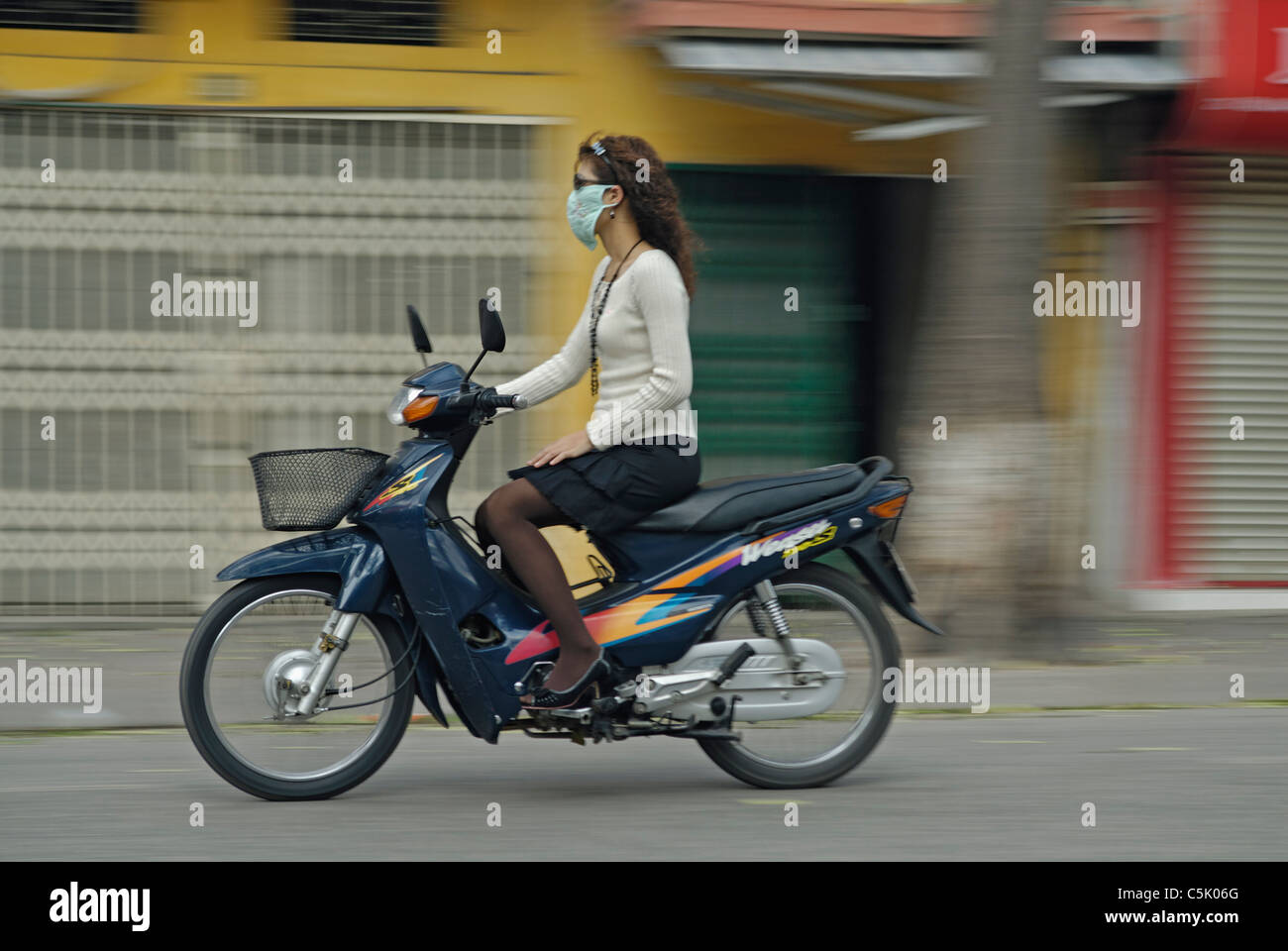 Asia, Vietnam, Hanoi. Hanoi old quarter. Girl with face mask on ...