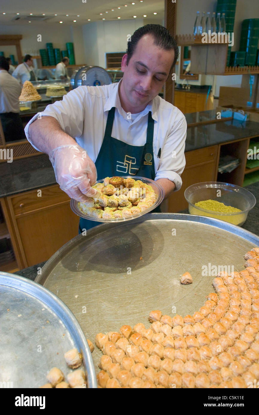 Man preparing portions of dessert, Beirut, Lebanon Stock Photo - Alamy