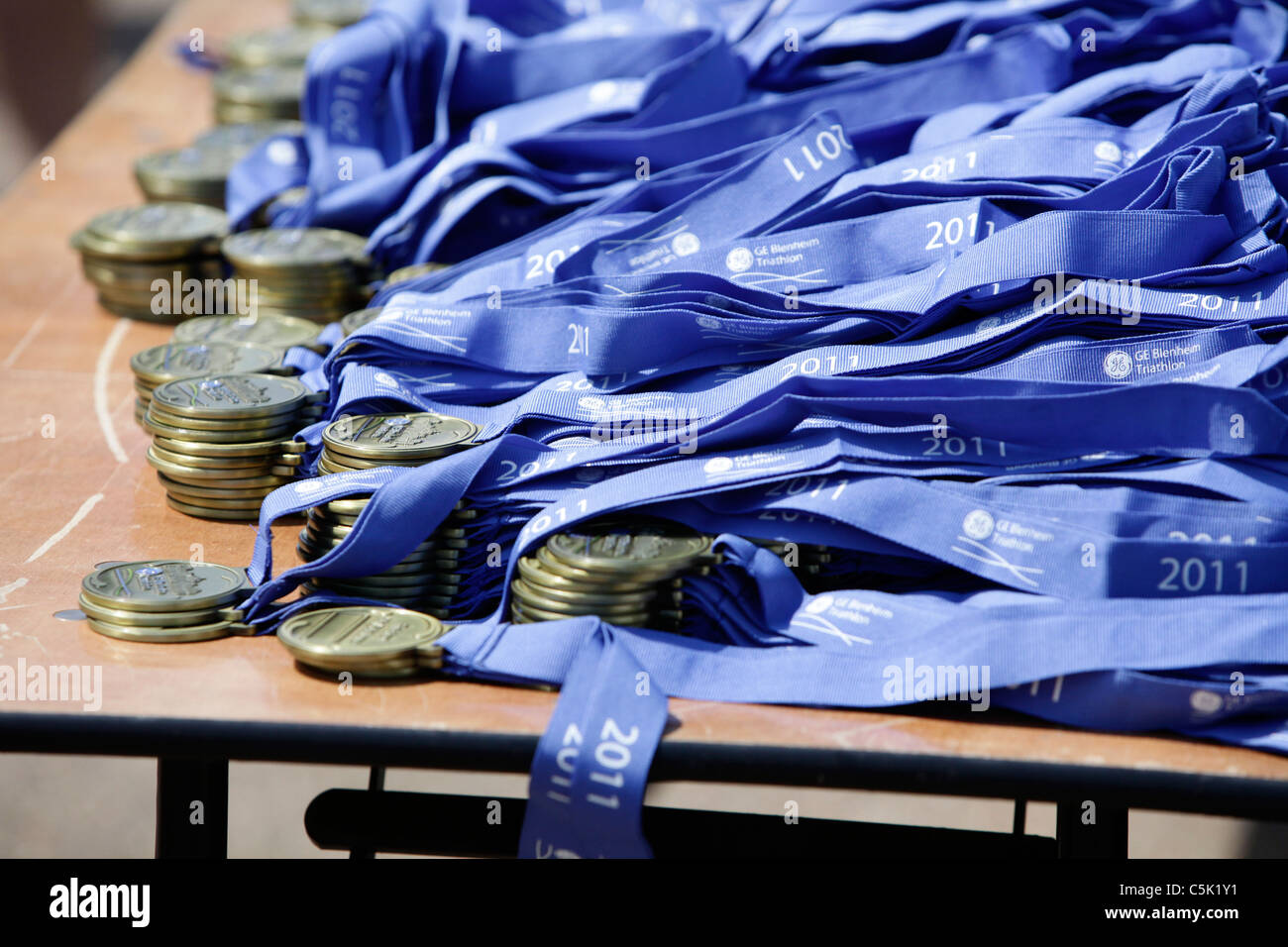 A stack of medals with blue ribbons, for use at a tri-athlon event in ...