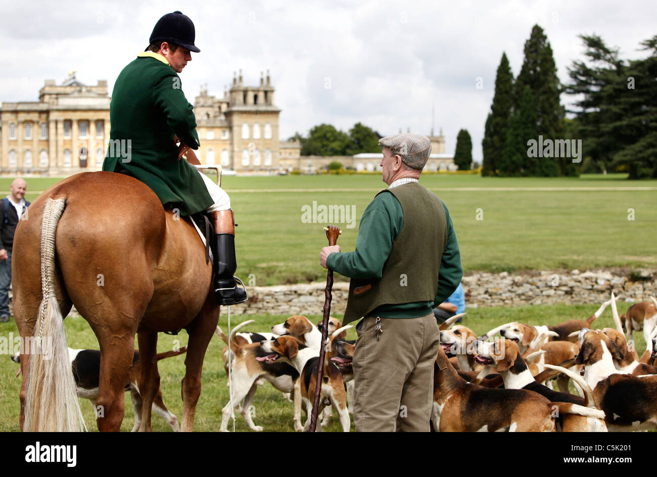 A countryman talking a mounted huntsman with Blenheim Palace in the ...