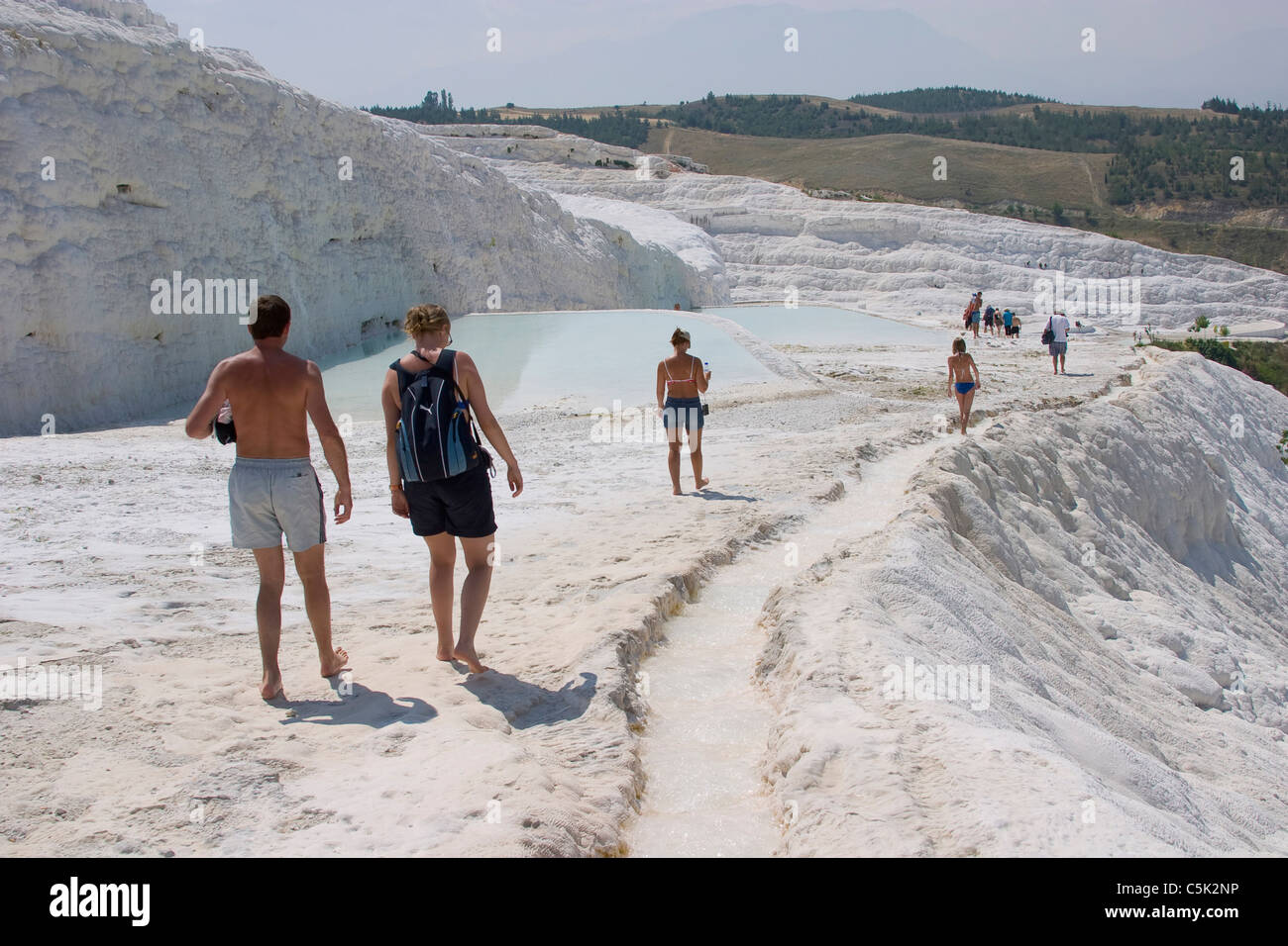 Tourists walking on travertine rocks, Pamukkale (ancient Hierapolis ...