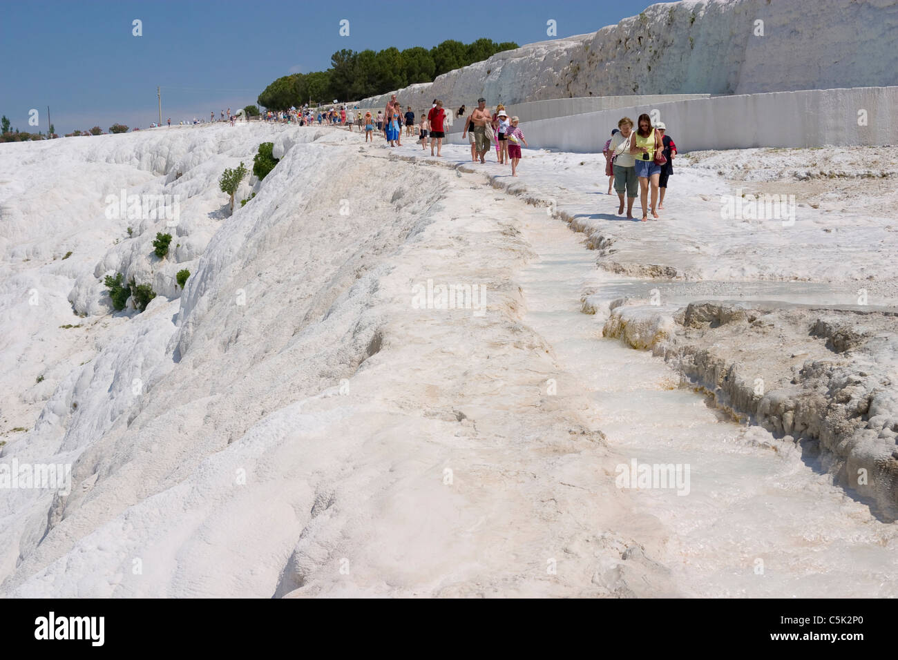 Tourists walking on travertine rocks, Pamukkale (ancient Hierapolis ...