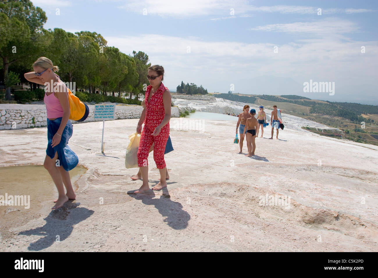 Tourists walking on travertine rocks, Pamukkale (ancient Hierapolis ...