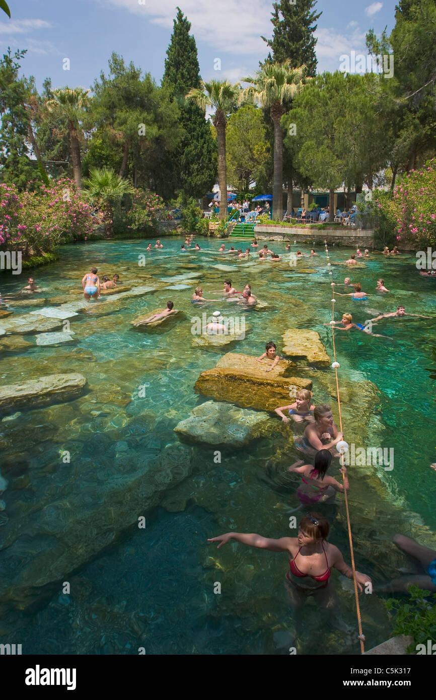 Tourists bathing and swimming in the ancient Sacred Pool of Hierapolis ...