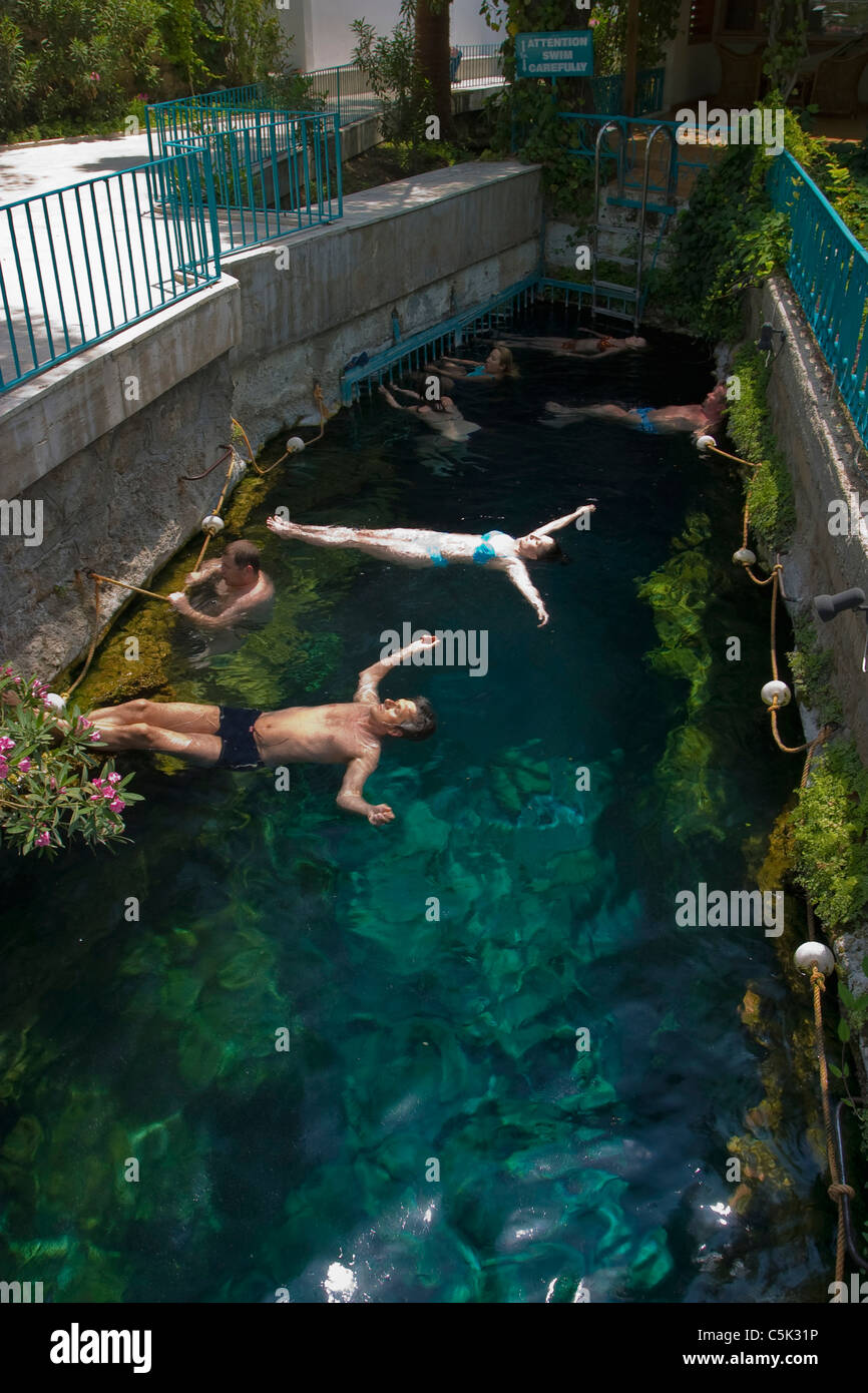 Tourists bathing and swimming in the ancient Sacred Pool of Hierapolis ...