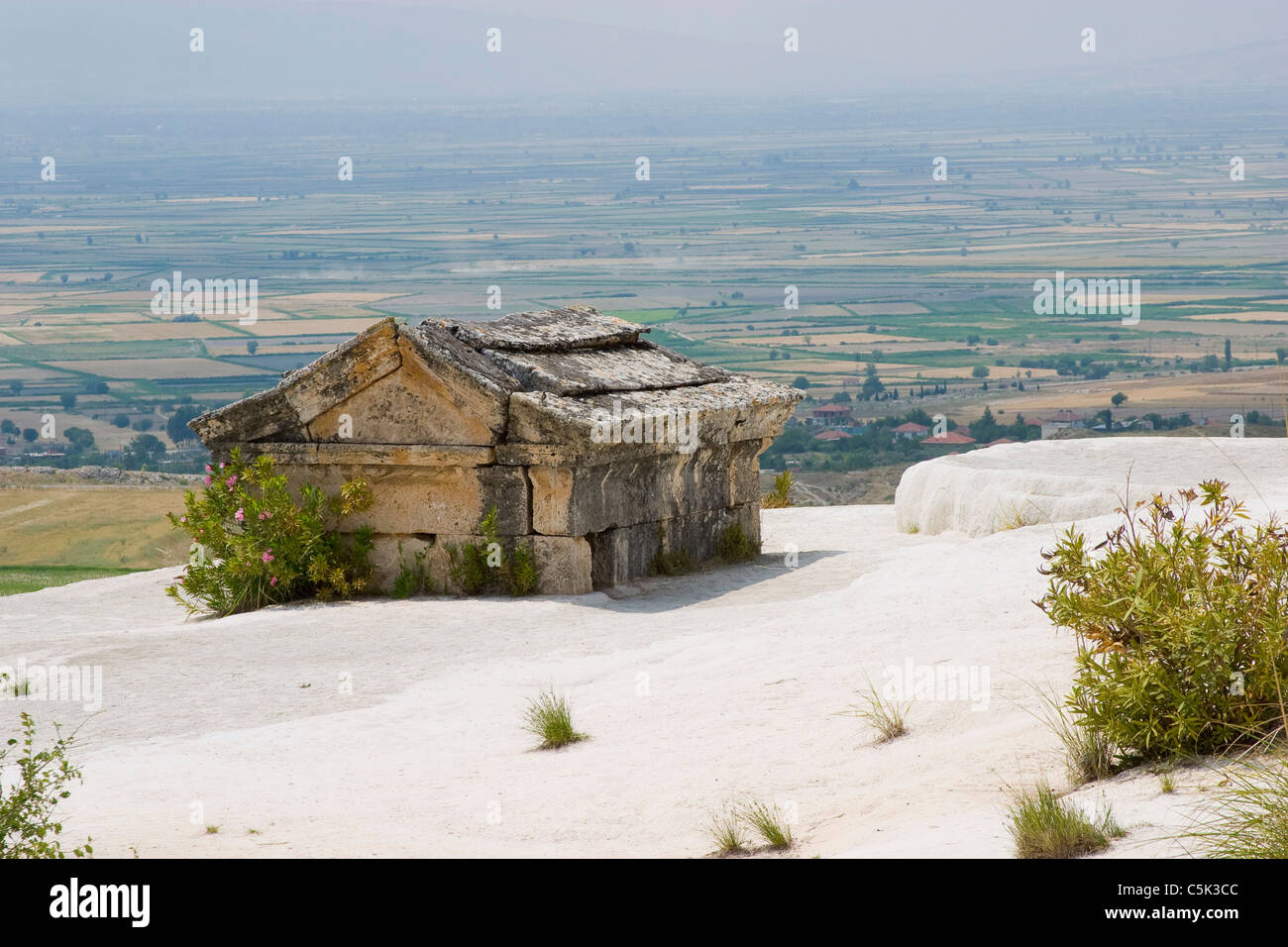 Sarcophagus embedded in white travertine rocks of Pamukkale (ancient ...
