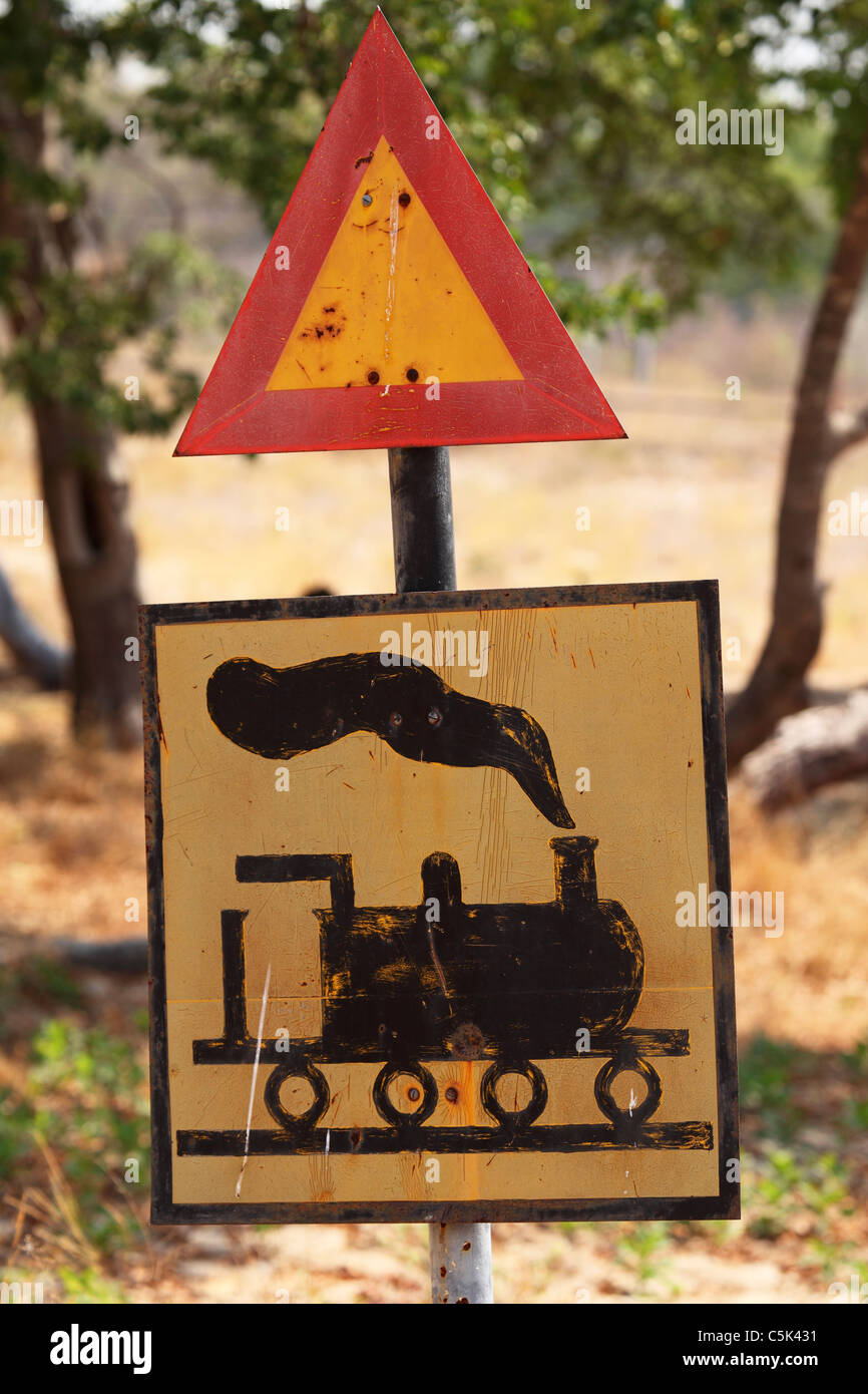 A sun-bleached and weather worn sign warns of the railway lines that ...