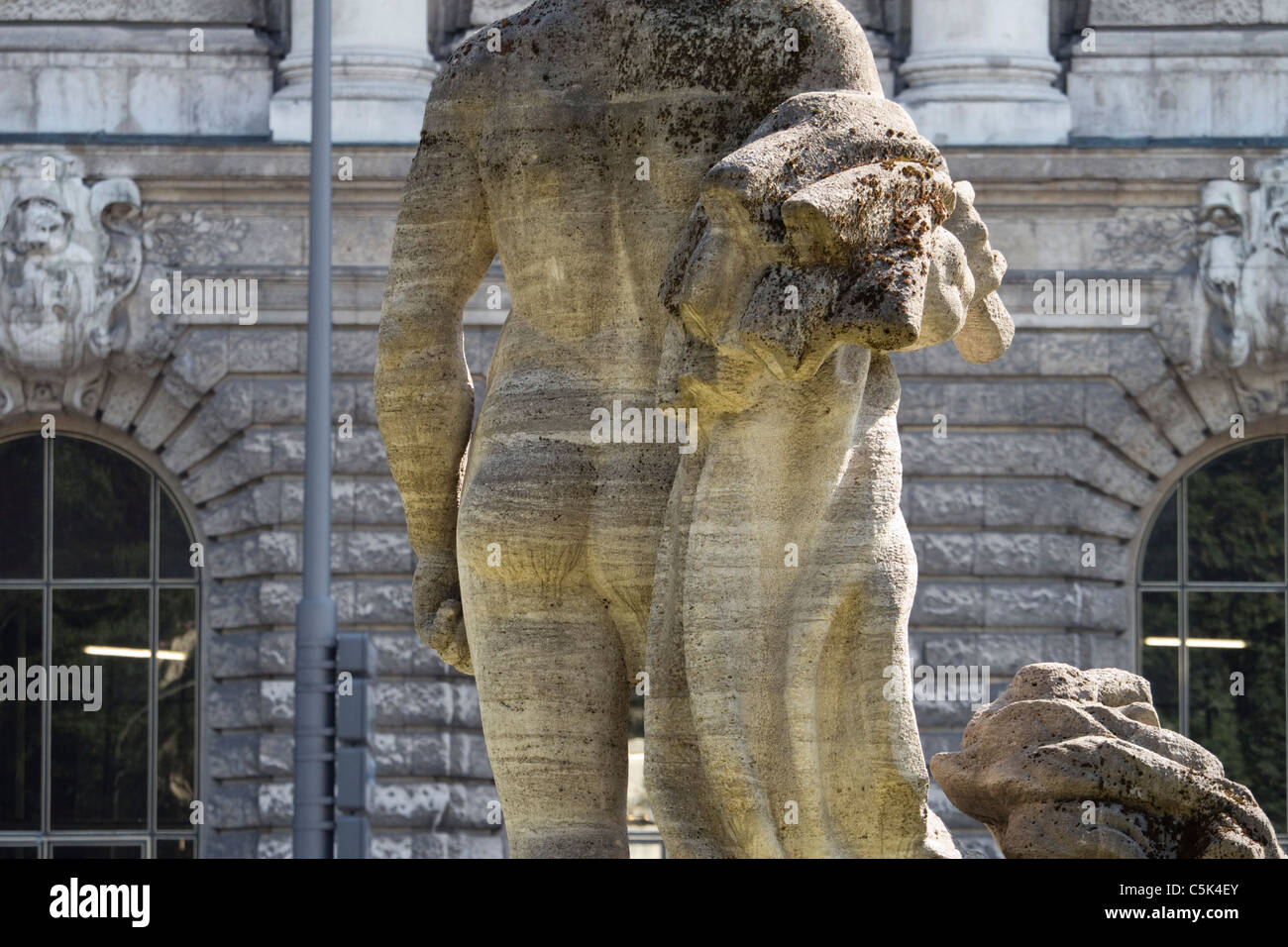 Backside of statue at fountain in Munich city centre Stock Photo - Alamy
