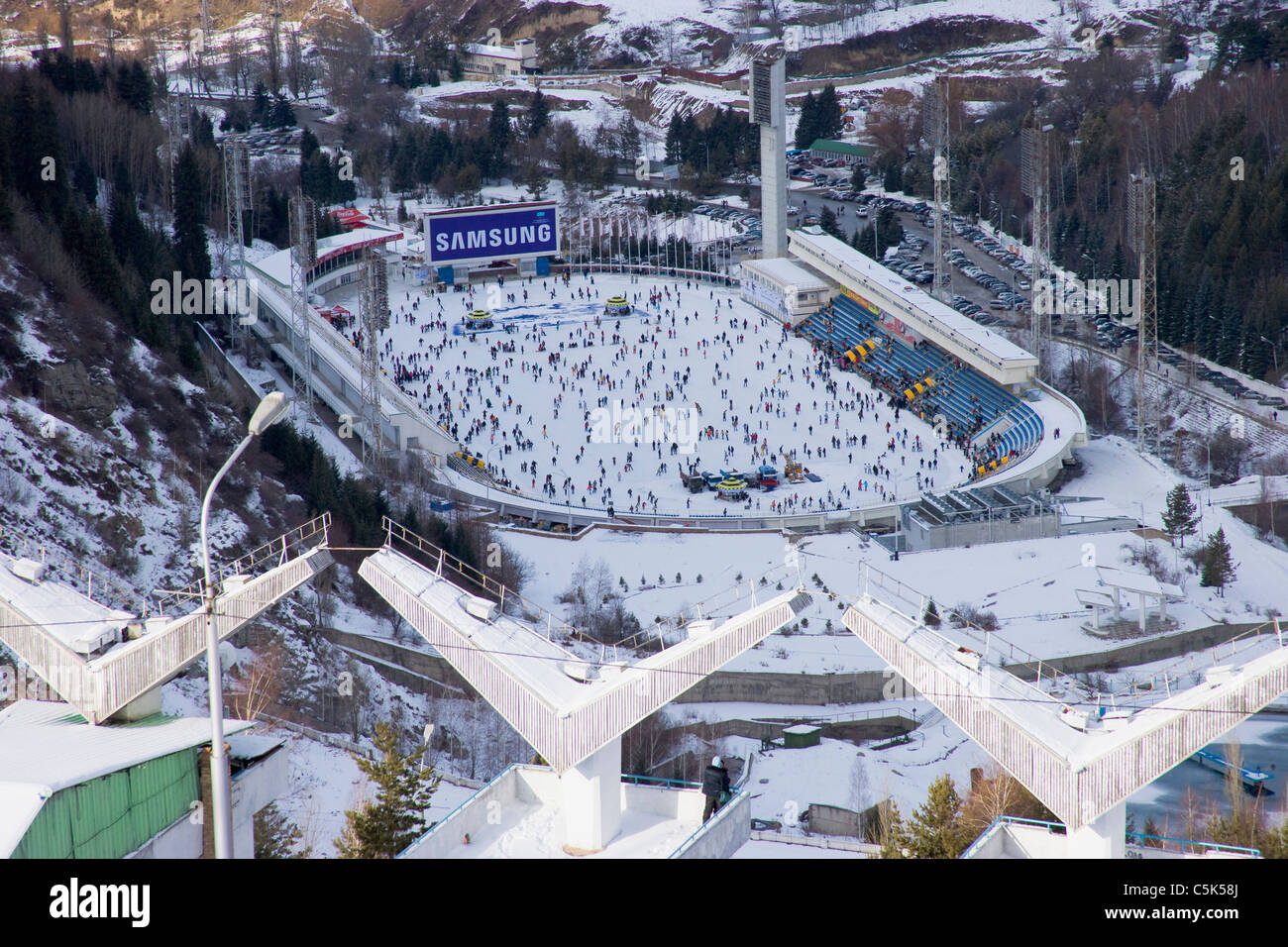 People skating at Medeo skating rink amongst mountains, Kazakhstan ...