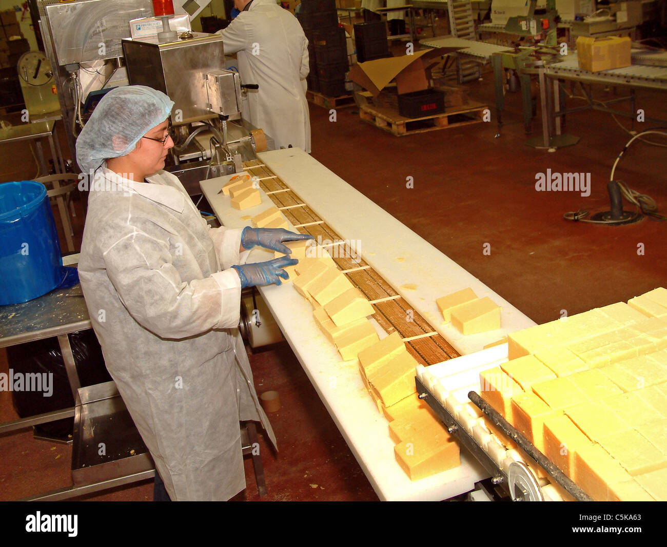 Weighing and Packing individual packs of cheddar cheese Stock Photo - Alamy