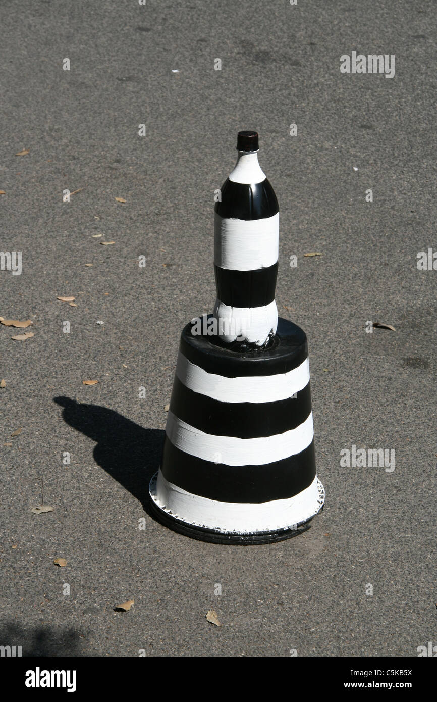 one single home made black and white stripes traffic cone in street ...