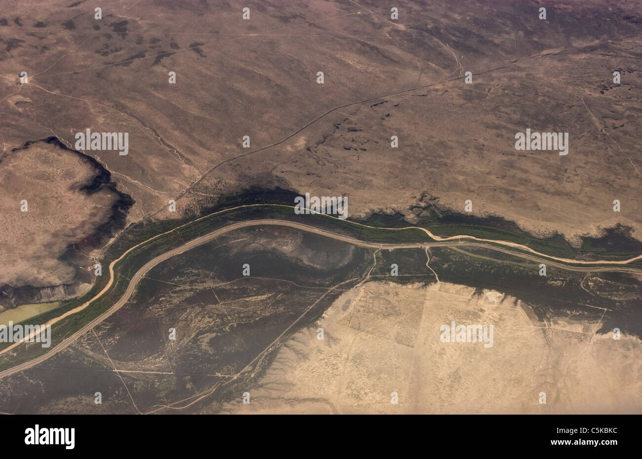 An aerial view of a road and riverbed in a desert area Stock Photo - Alamy