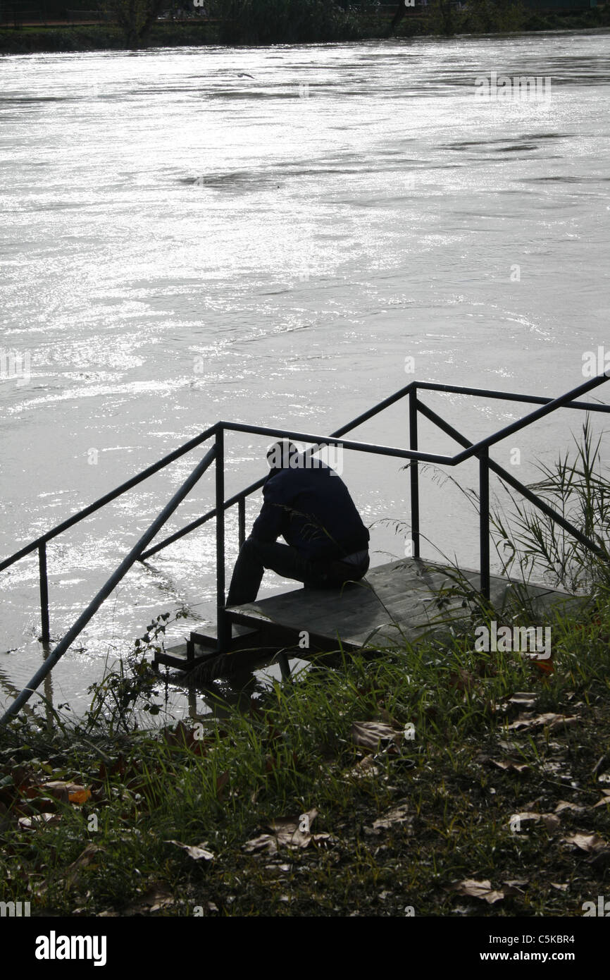 man sitting by tiber flood river in rome italy Stock Photo - Alamy