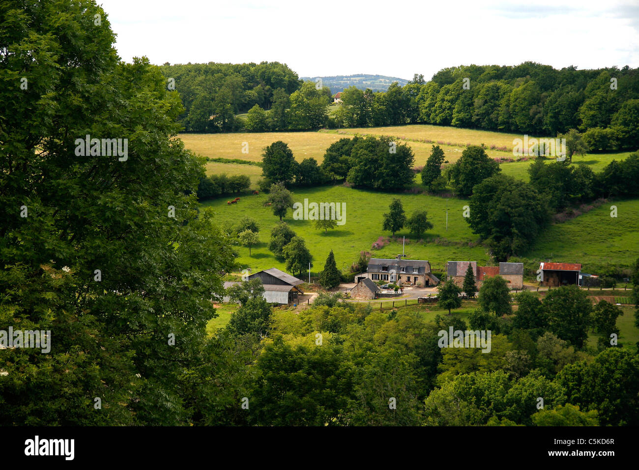 Undulating landscape with a farm. Rolling countryside in Normandy, at ...