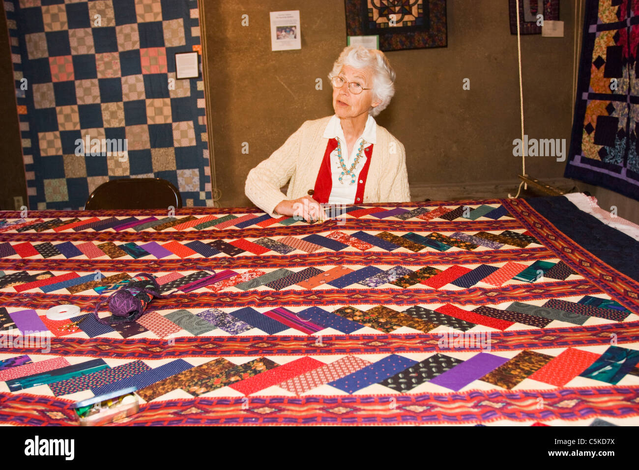 Senior artist makes quilt Stock Photo - Alamy