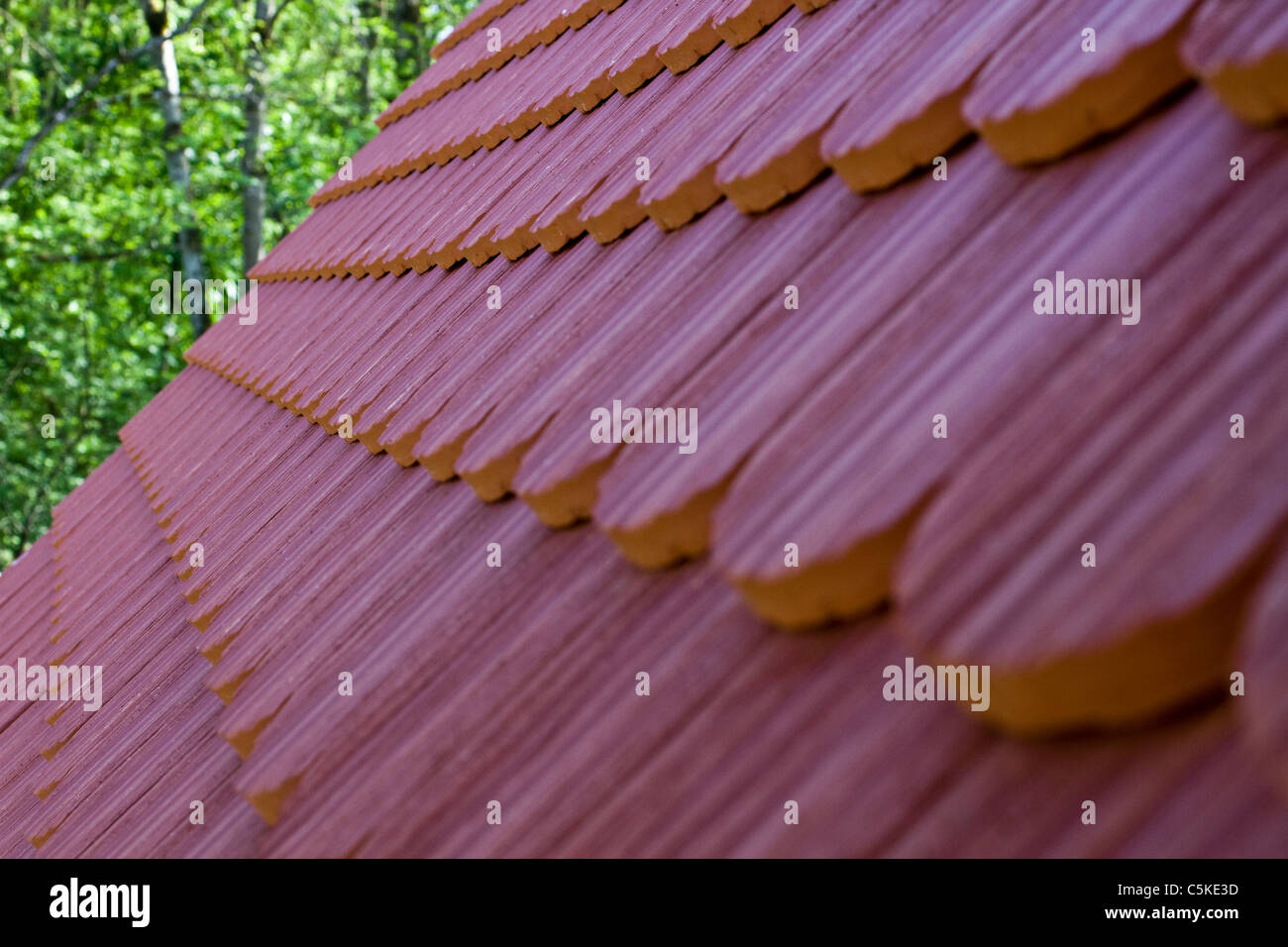 copper eaves gutter with blurred roof tiles Stock Photo - Alamy