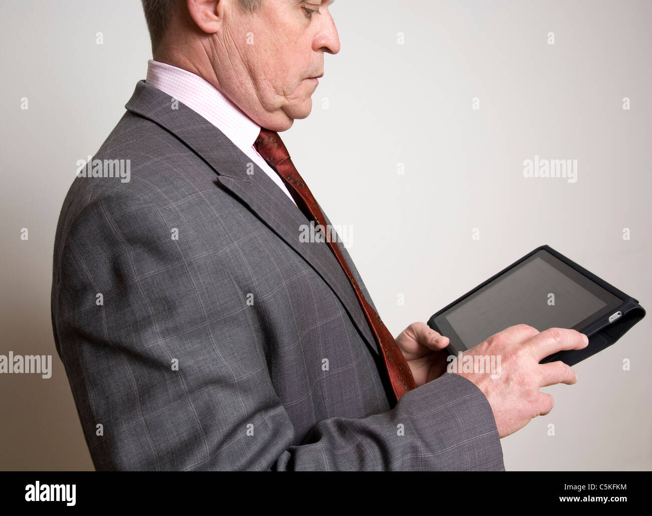 Man holding and looking at graph on ipad Stock Photo - Alamy