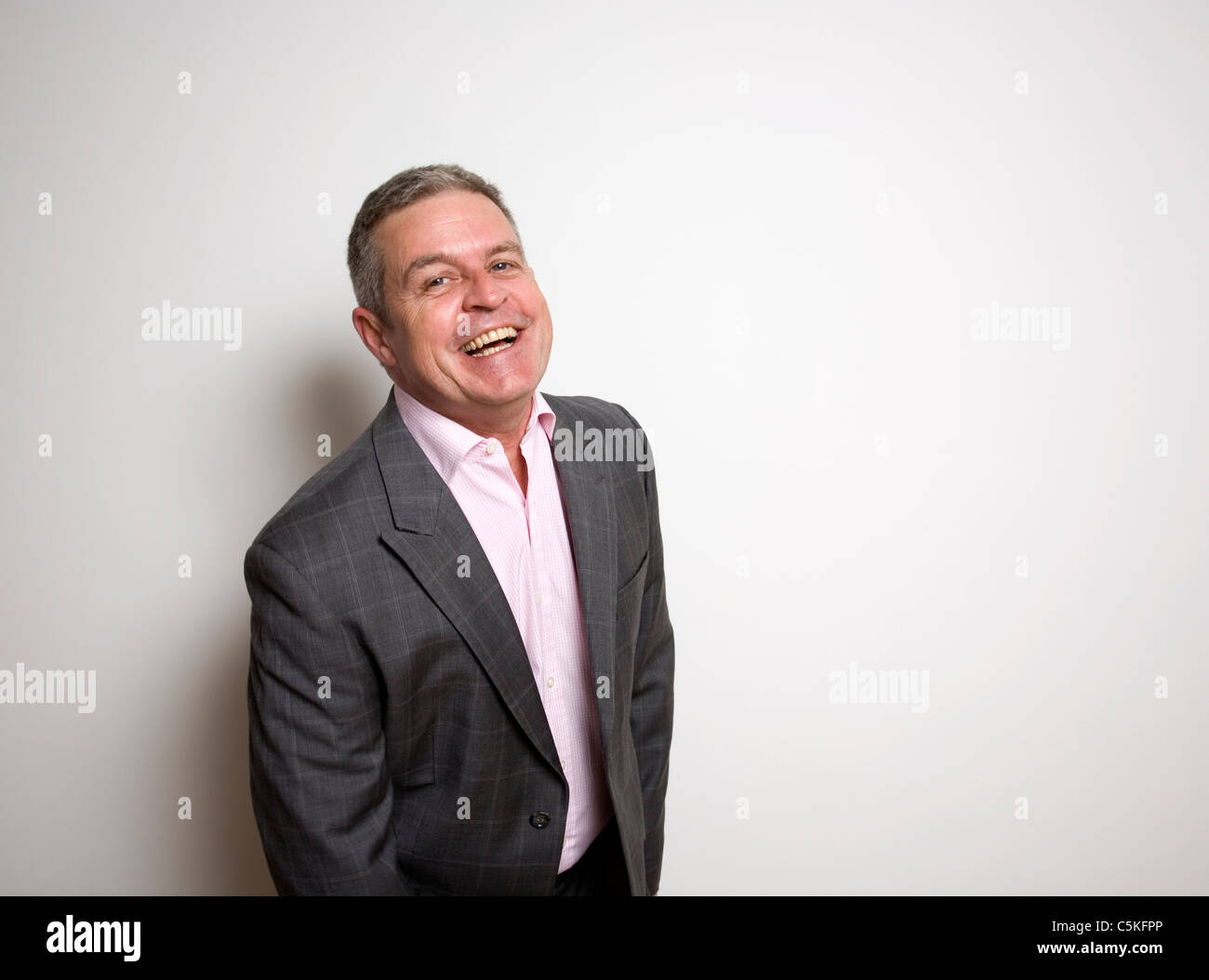 Businessman laughing - studio shot Stock Photo - Alamy
