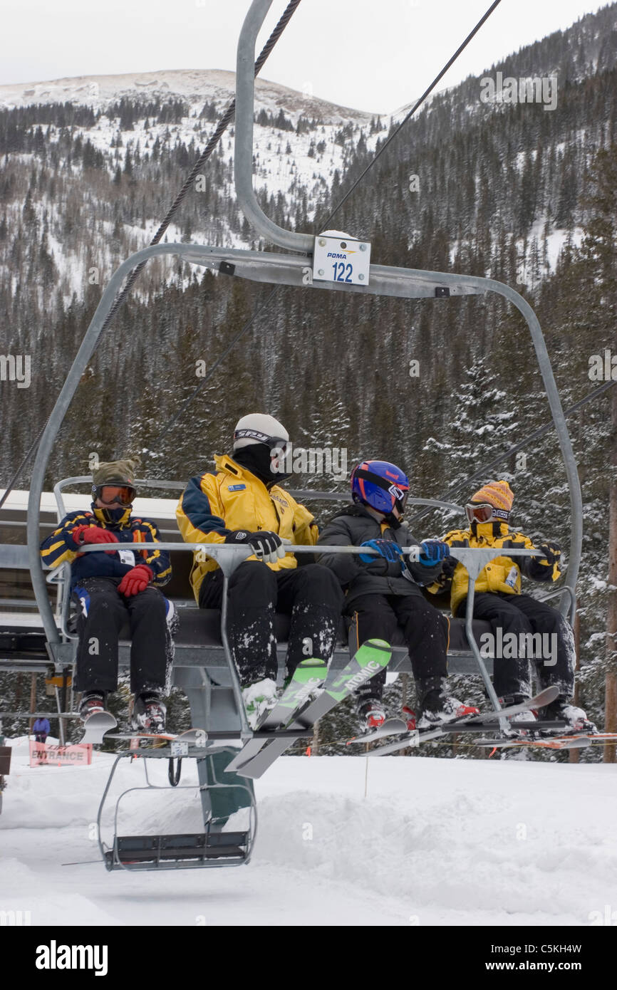 Vertical closeup of family on chair lift Stock Photo - Alamy