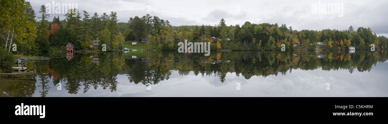 Buildings and trees reflected in Partridge Lake, NH Stock Photo - Alamy