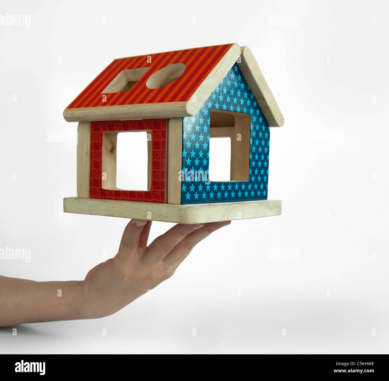 Wood colorful house toy in hand Stock Photo - Alamy
